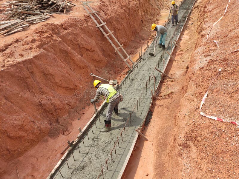 Construction Workers are Levelling a Layer of Lean Concrete in the ...