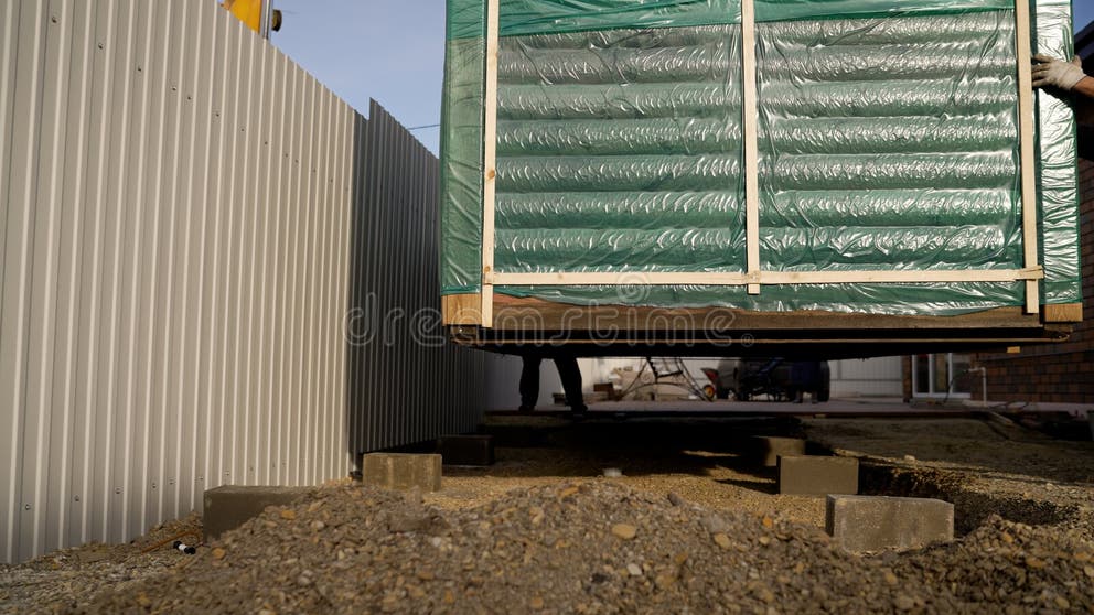 Construction Workers Lifting Prefabricated House Module with Crane ...