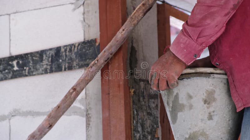 Construction Workers Man Using Containers To Pour Mixed Cement into ...