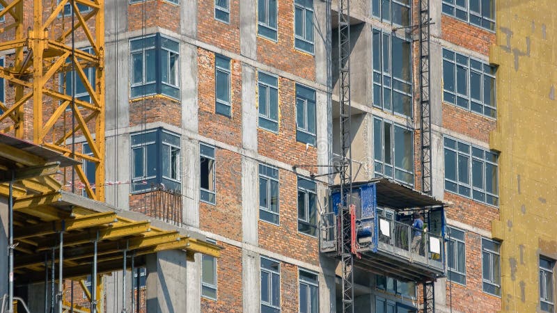 Construction Workers Moving Down on the Elevator. Stock Photo - Image ...