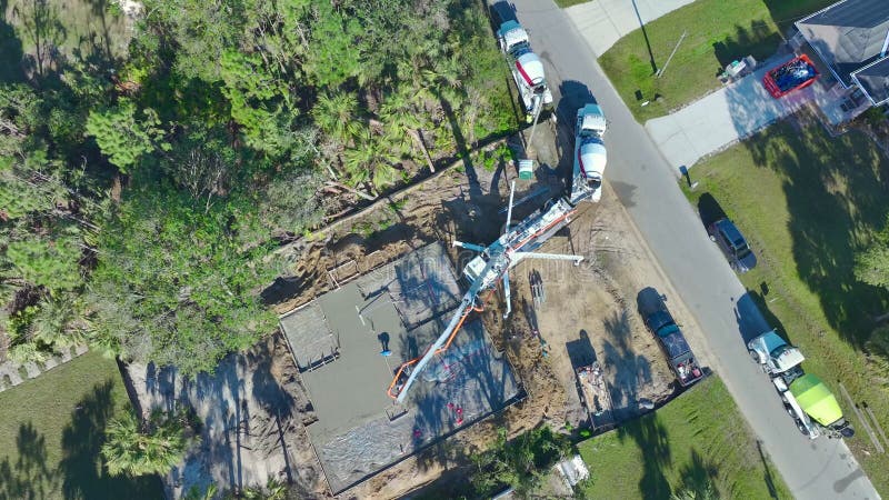 Construction Workers at New House Building Site Pouring Concrete of ...
