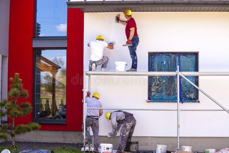 Construction Workers Plaster the Facade of the House. Stock Image ...