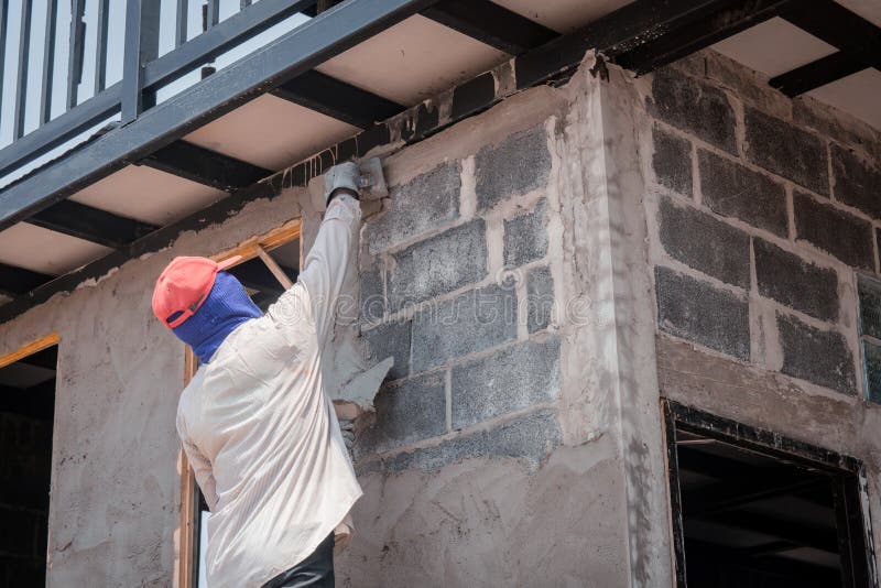 Construction Workers Plastering Building Wall Using Cement Plaster ...