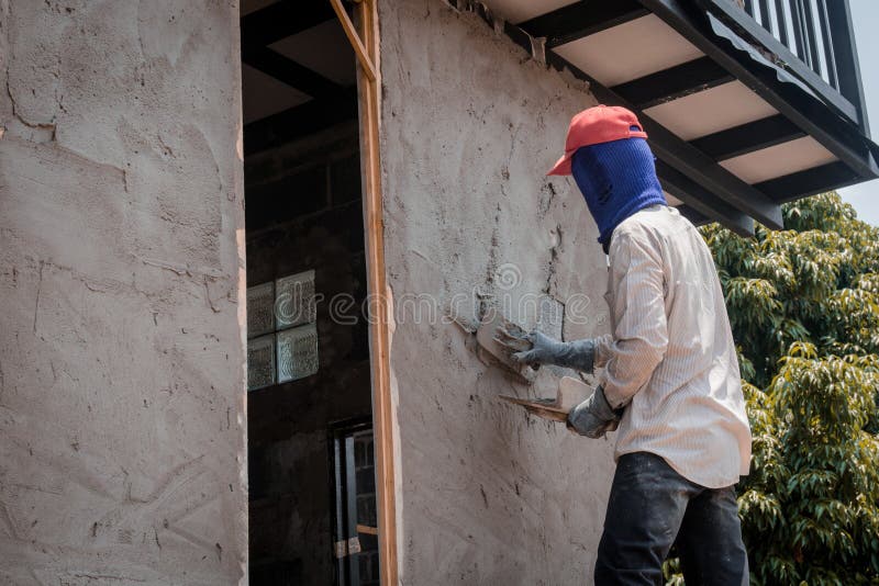 Construction Workers Plastering Building Wall Using Cement Plaster ...