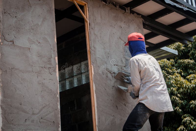Construction Workers Plastering Building Wall Using Cement Plaster ...