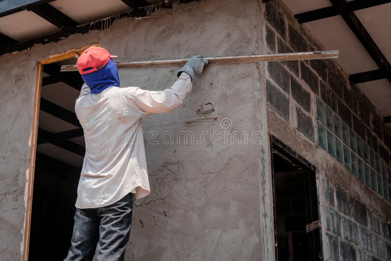 Construction Workers Plastering Building Wall Using Cement Plaster ...