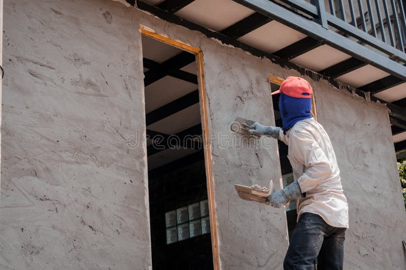 Construction Workers Plastering Building Wall Using Cement Plaster ...