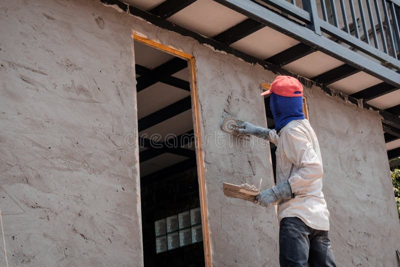 Construction Workers Plastering Building Wall Using Cement Plaster ...