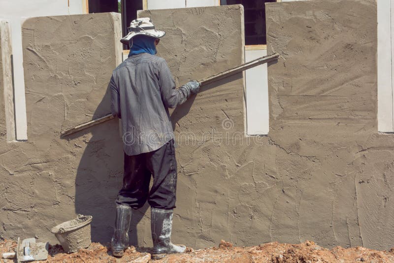 Construction Workers Plastering Building Wall Using Cement Plaster ...