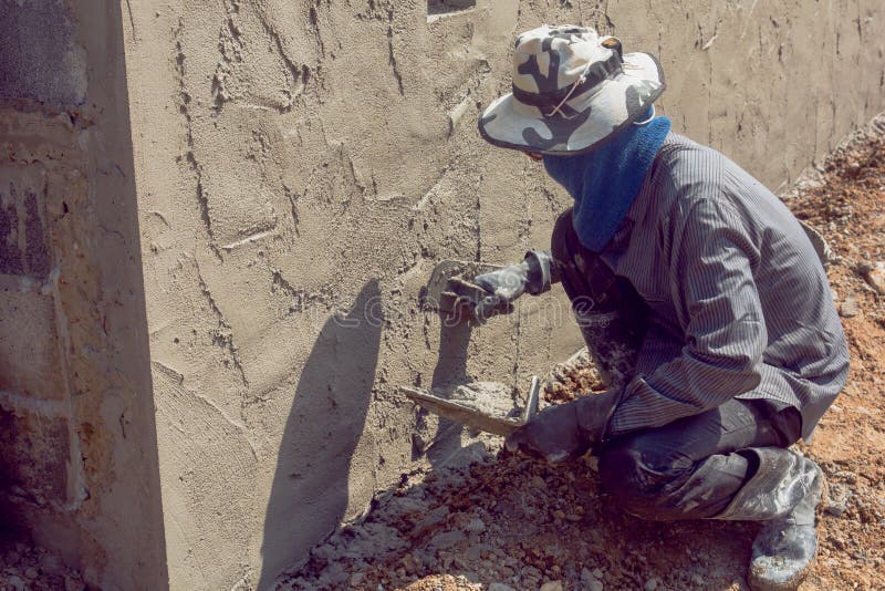 Construction Workers Plastering Building Wall Using Cement Plaster ...
