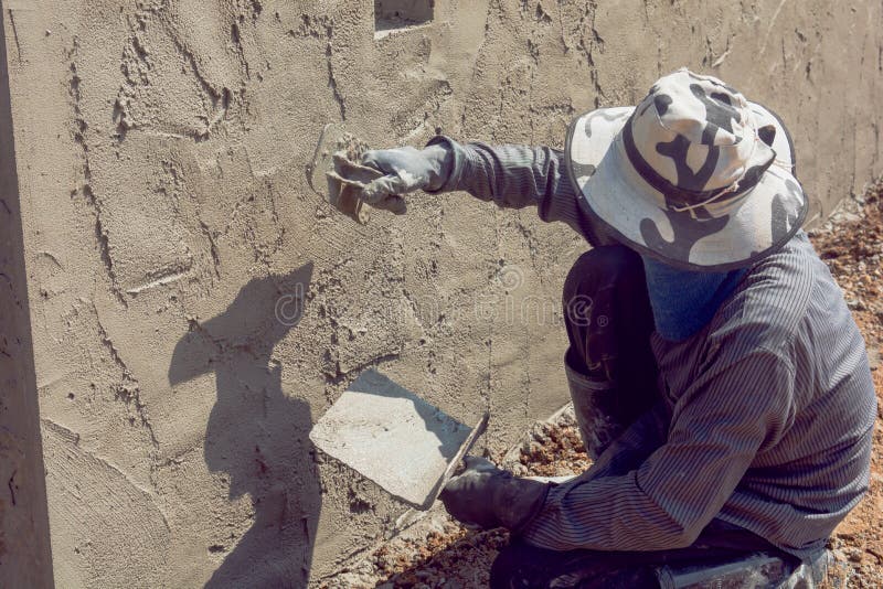 Construction Workers Plastering Building Wall Using Cement Plaster ...