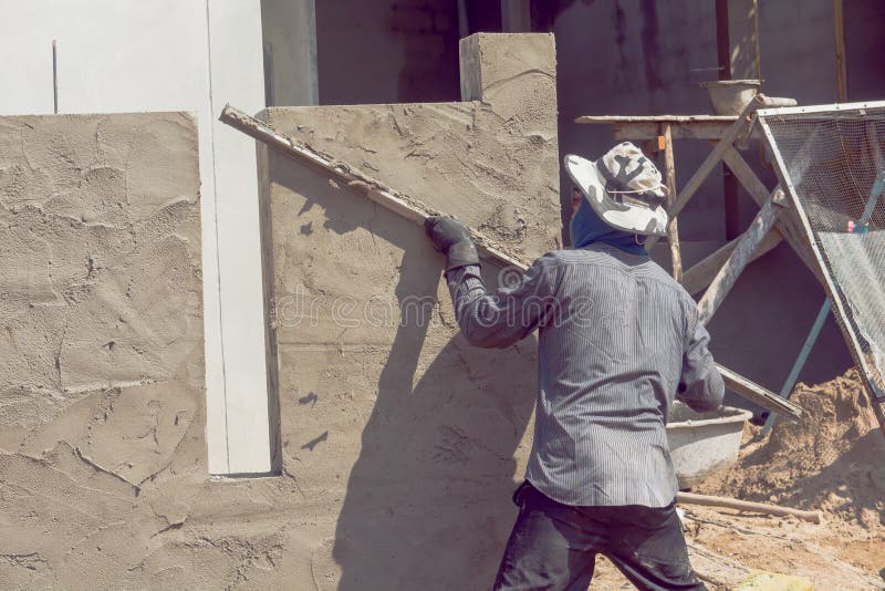 Construction Workers Plastering Building Wall Using Cement Plaster ...