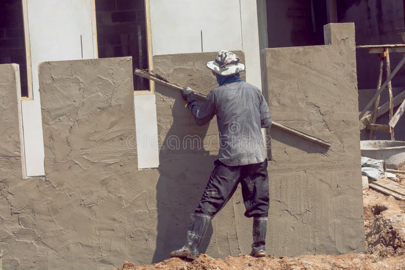 Construction Workers Plastering Building Wall Using Cement Plaster ...