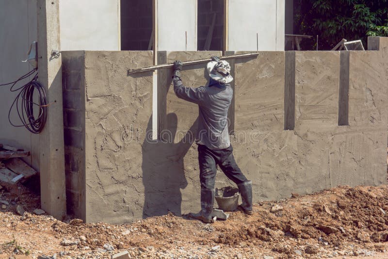 Construction Workers Plastering Building Wall Using Cement Plaster ...