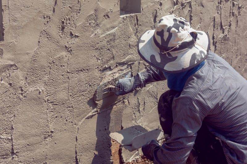 Construction Workers Plastering Building Wall Using Cement Plaster ...