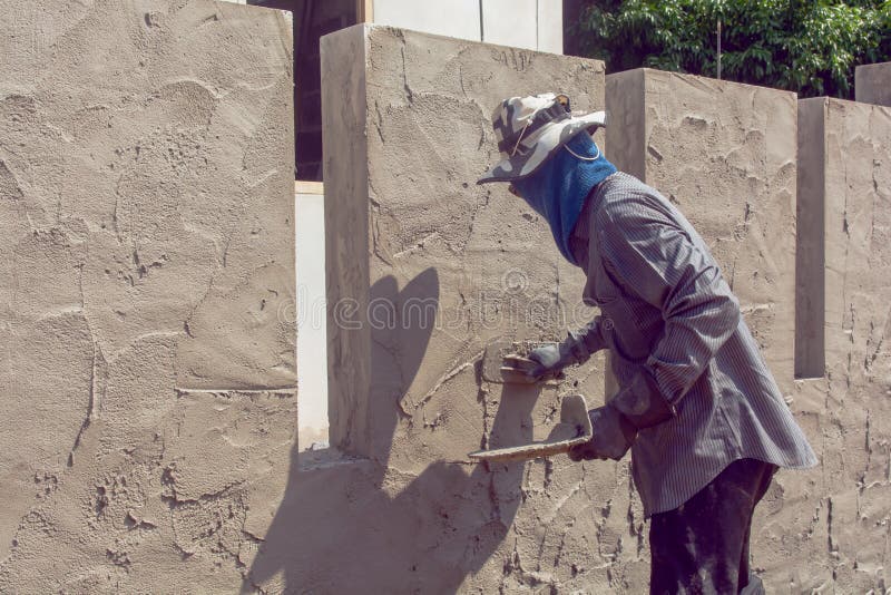 Construction Workers Plastering Building Wall Using Cement Plaster ...