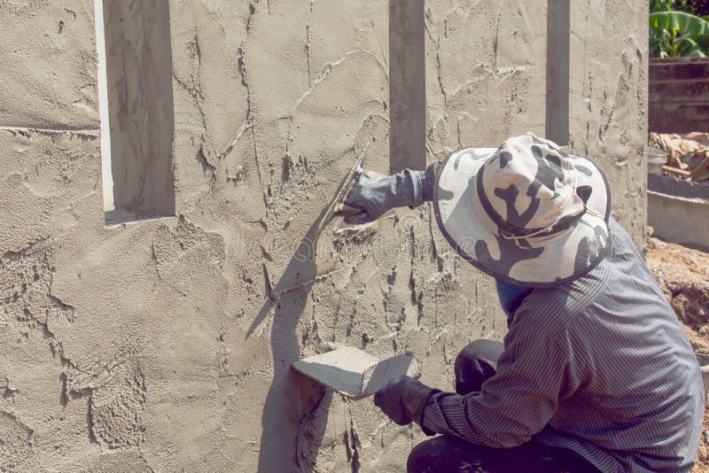 Construction Workers Plastering Building Wall Using Cement Plaster ...