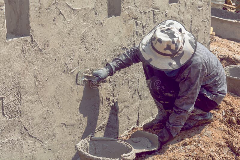 Construction Workers Plastering Building Wall Using Cement Plaster ...
