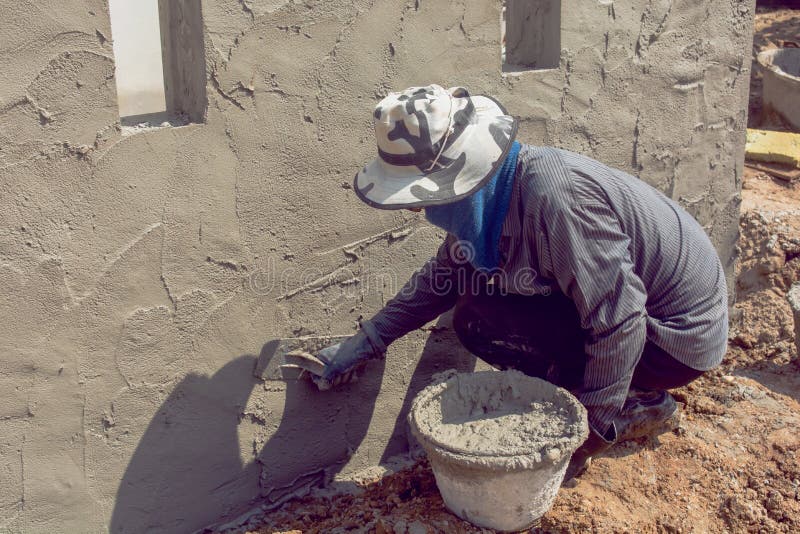Construction Workers Plastering Building Wall Using Cement Plaster ...