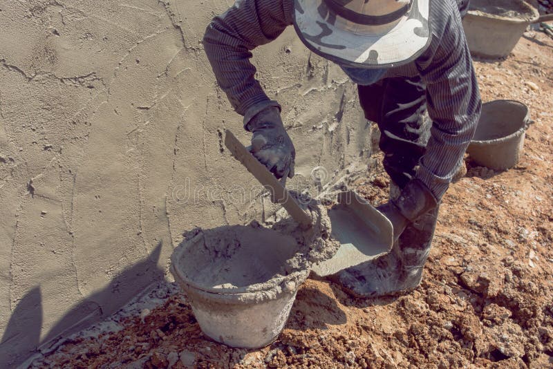 Construction Workers Plastering Building Wall Using Cement Plaster ...