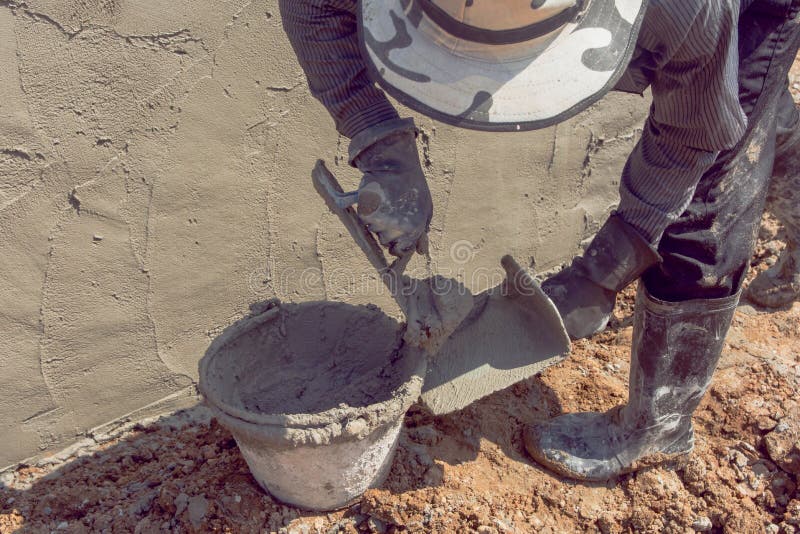 Construction Workers Plastering Building Wall Using Cement Plaster ...