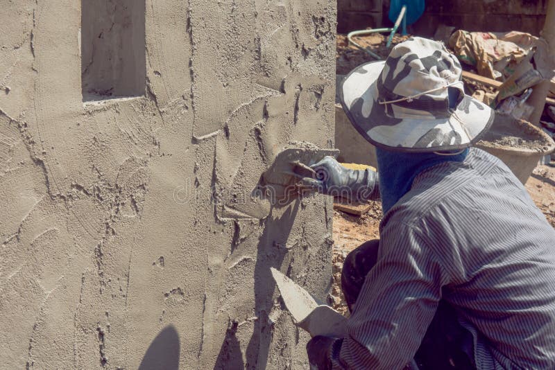 Construction Workers Plastering Building Wall Using Cement Plaster ...