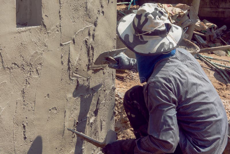 Construction Workers Plastering Building Wall Using Cement Plaster ...