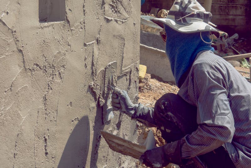 Construction Workers Plastering Building Wall Using Cement Plaster ...