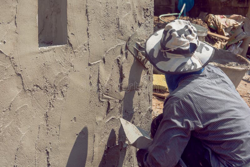 Construction Workers Plastering Building Wall Using Cement Plaster ...