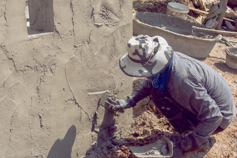 Construction Workers Plastering Building Wall Using Cement Plaster ...