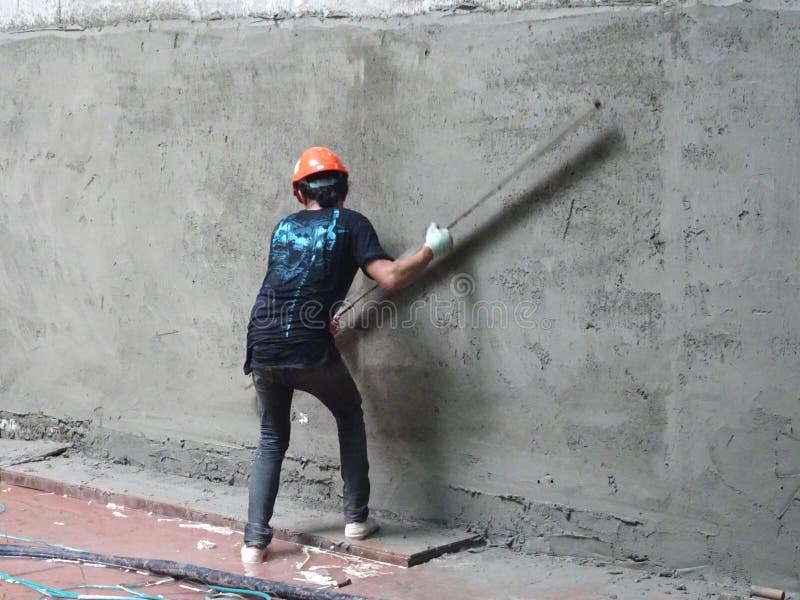 Construction Workers Plastering Building Wall Using Cement Plaster with ...