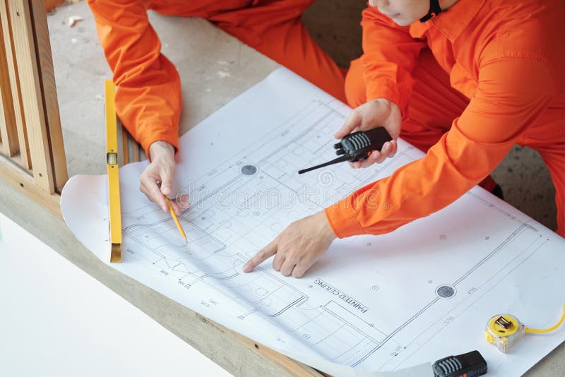 Construction Workers Pointing at Building Blueprint Stock Image - Image ...
