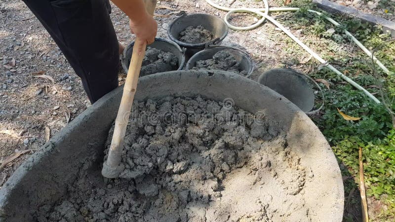 Construction Workers Pouring Cement into Buckets Stock Footage - Video ...