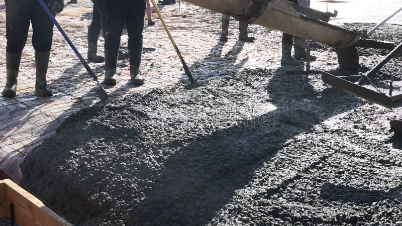 Construction Workers Pouring Concrete at a Building Site in Bright ...