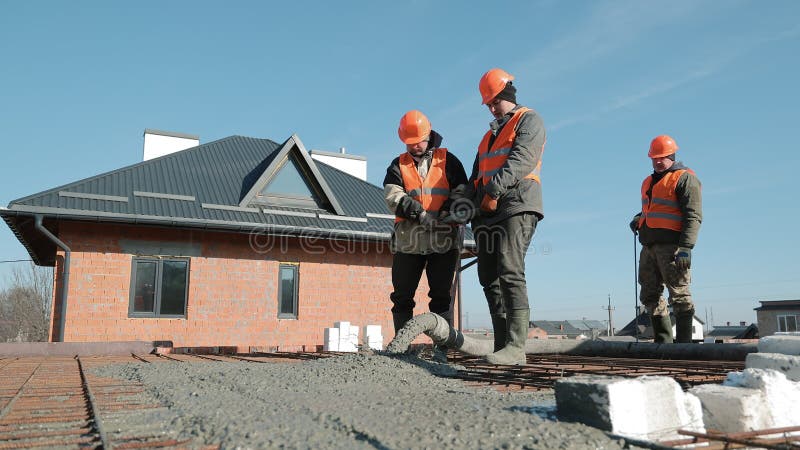Construction Workers Pouring Concrete on Rebar Foundation, Residential ...
