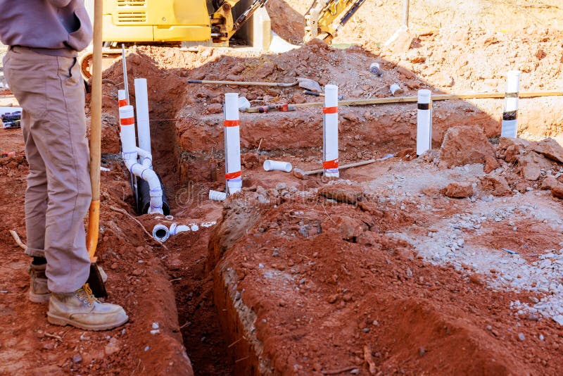 Construction Workers Prepare Trenches for Plumbing Installation at a ...