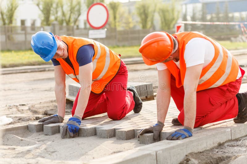Construction Workers Putting Paving Stones Stock Image - Image of ...