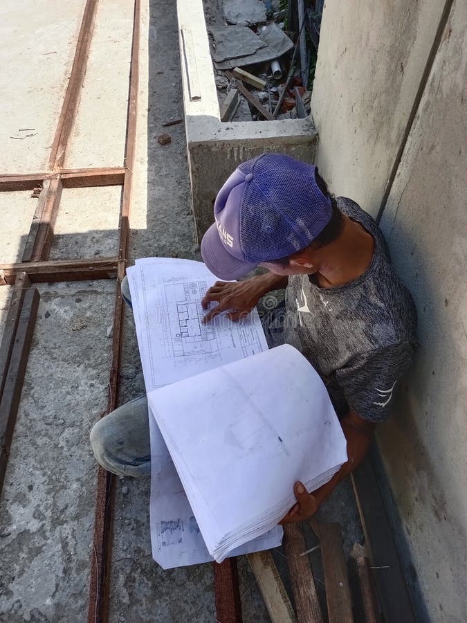 Construction Workers, Reading Project Working Drawings. Editorial ...