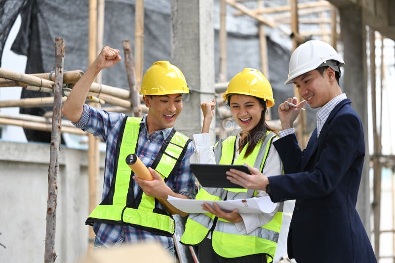 Construction Workers in Safety Helmets Celebrating a Successful Project ...