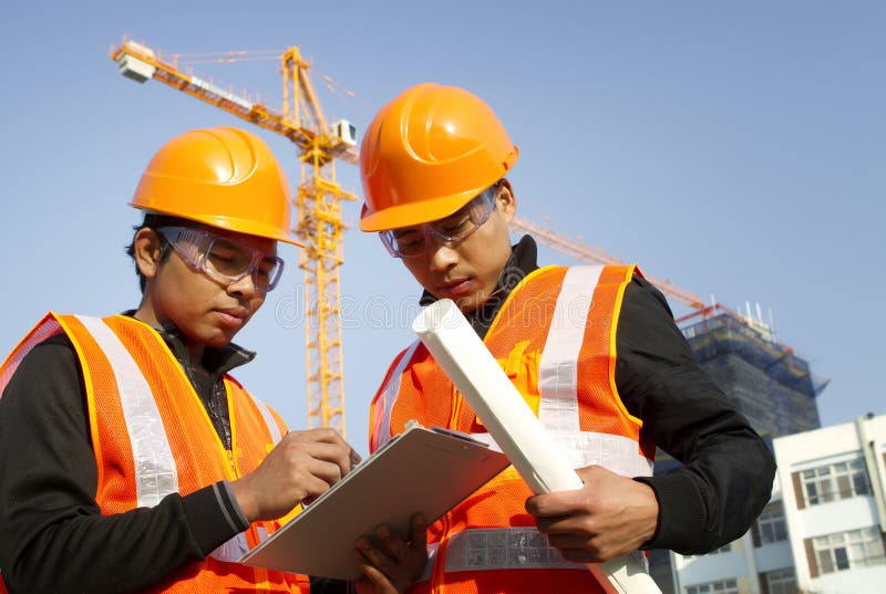 Construction Co-workers Discussing Stock Image - Image of blue, male ...