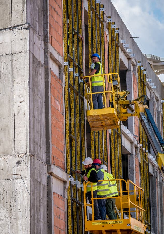 Construction Workers on a Scaffold. Men Working at a Buildingfrom a ...