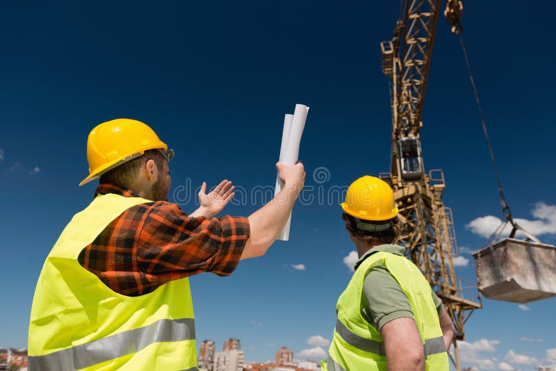 Construction Workers Signaling To Crane Operator Stock Image - Image of ...