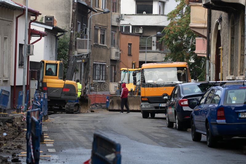 Construction Workers at Construction Site and Heavy Duty Bulldozer in ...