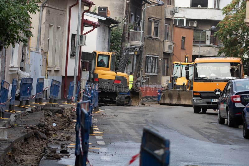 Construction Workers at Construction Site and Heavy Duty Bulldozer in ...