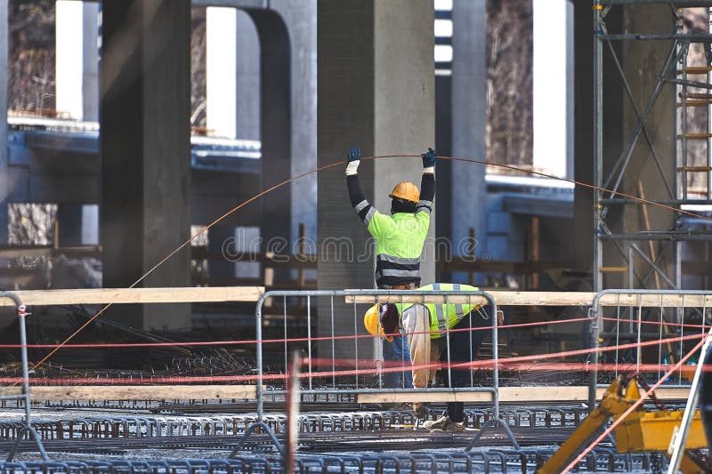 Construction Workers on the Construction Site Work with Concrete ...