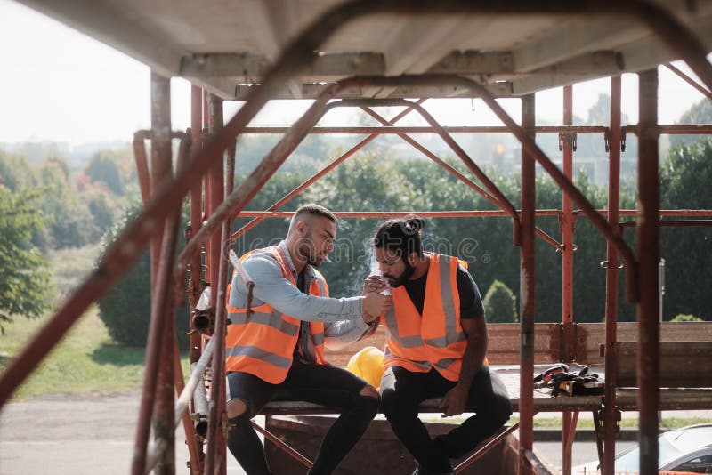 Construction Workers Smoking Cigarette and Talking on Break Stock Photo ...