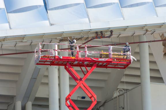 Construction Workers Standing in the Scissors Lifting Crane Bucket ...