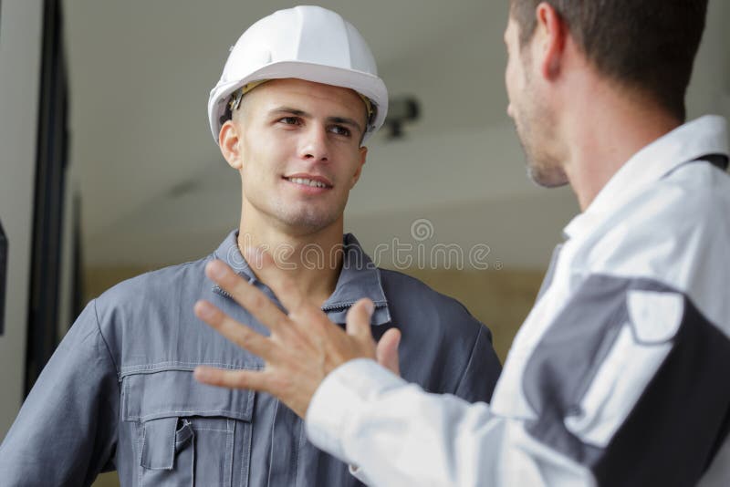 2 Construction Workers Talking Stock Image - Image of operate, trainee ...