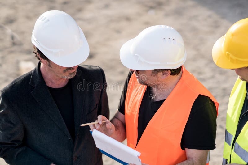 Construction Workers Talking on Construction Site Stock Image - Image ...
