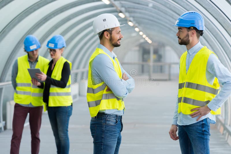Construction Workers Talking in Covered Walkway Stock Image - Image of ...